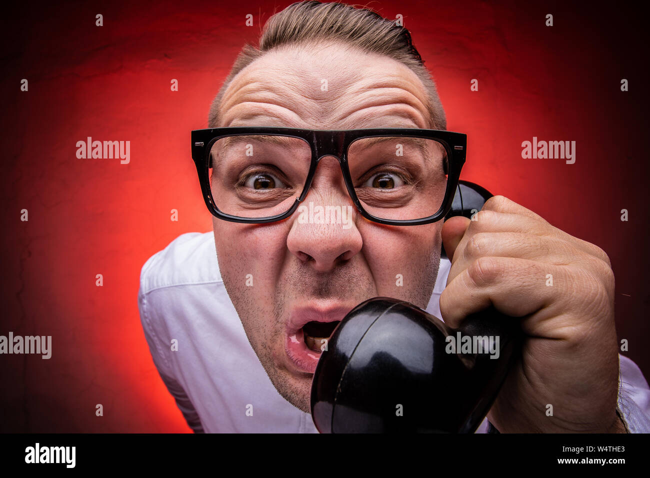 Hysterical and crazy boss screaming on the phone. Bad boss concept ...
