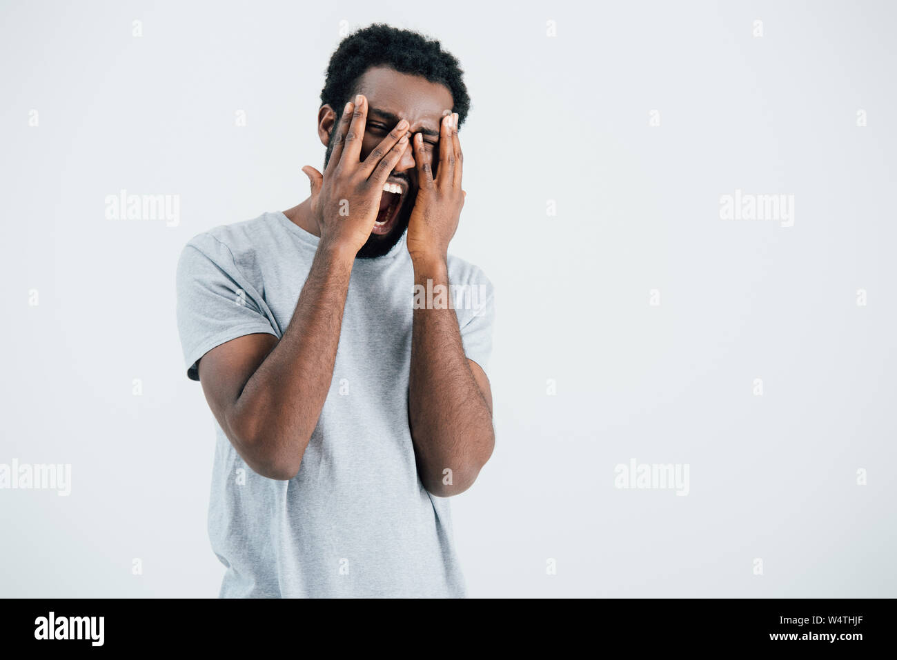 african american man in grey t-shirt screaming and crying isolated on ...