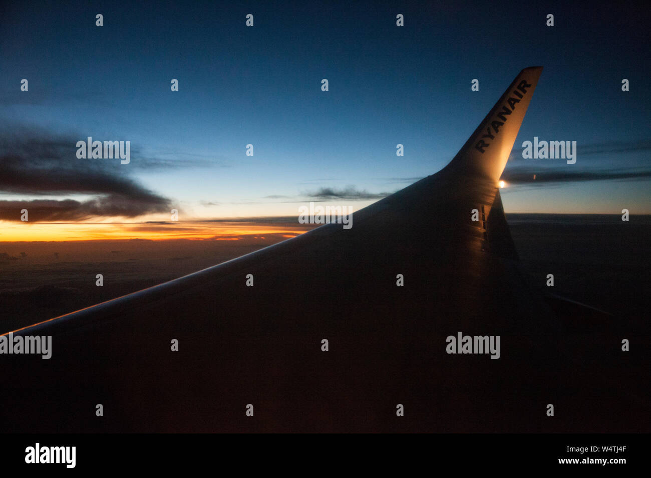 An evening view from the plane window to the wing of the plane Stock ...