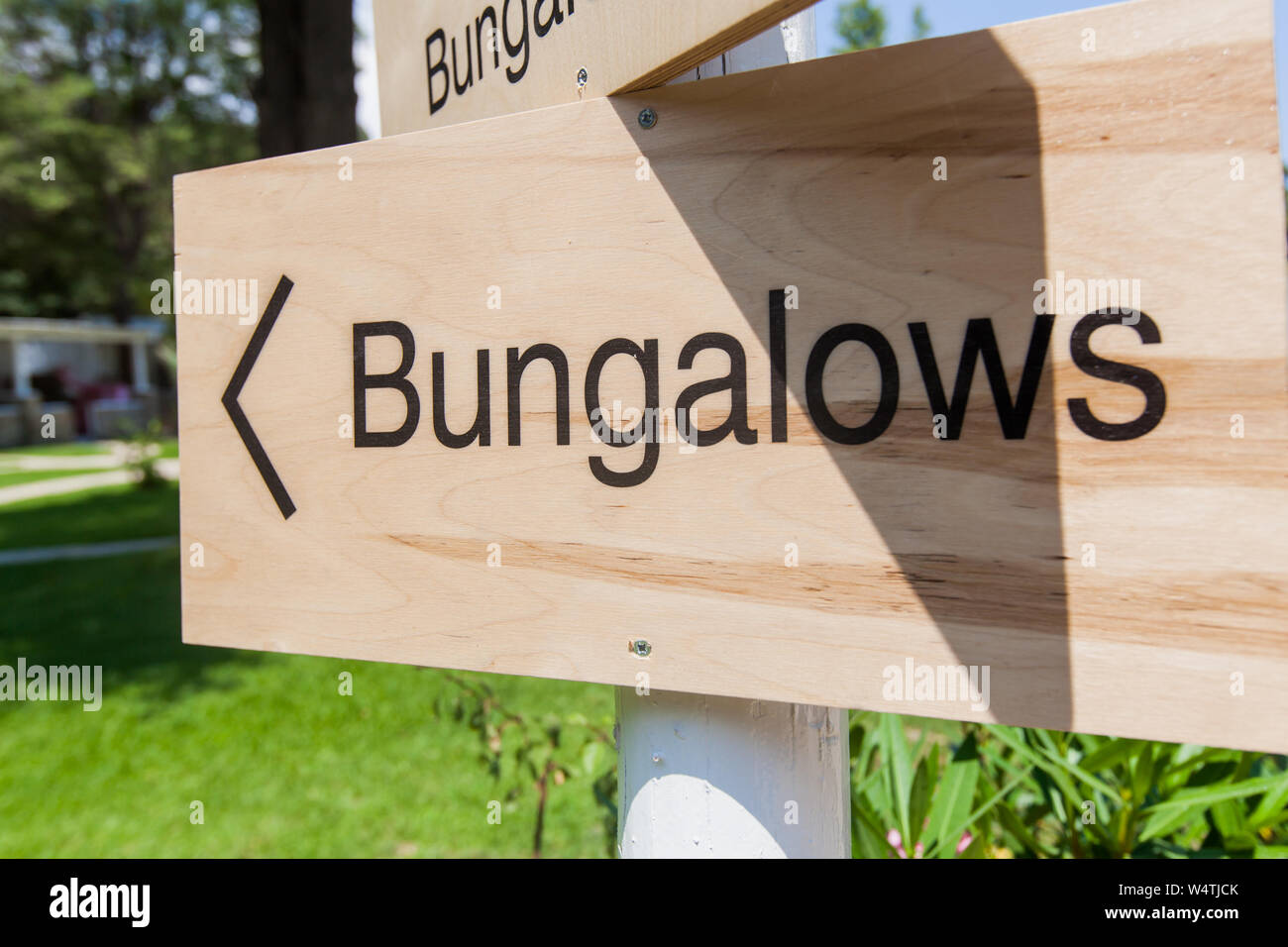 Wooden sign for bungalows on the beach Stock Photo - Alamy