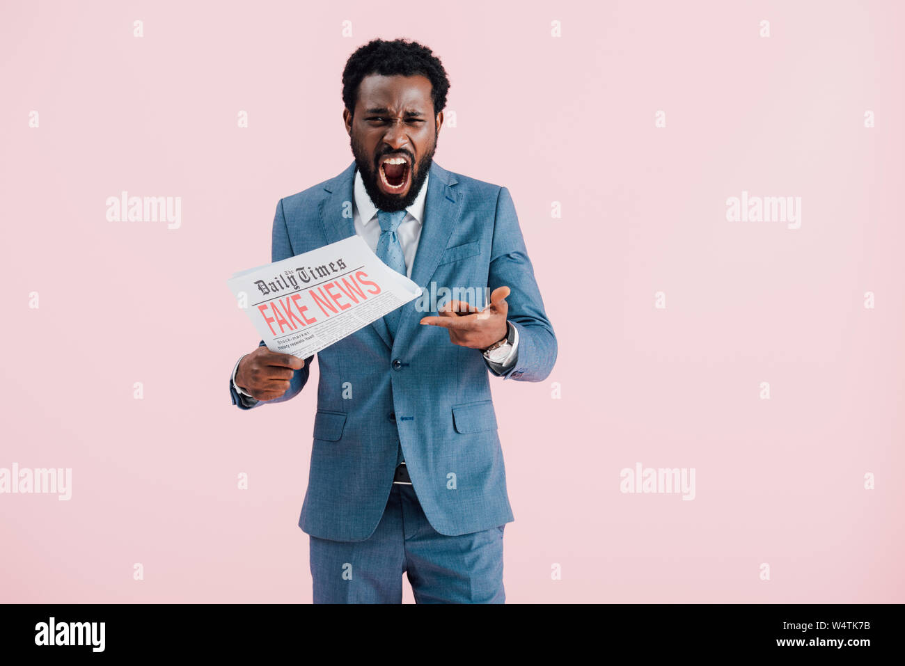 angry african american businessman yelling and reading newspaper with ...