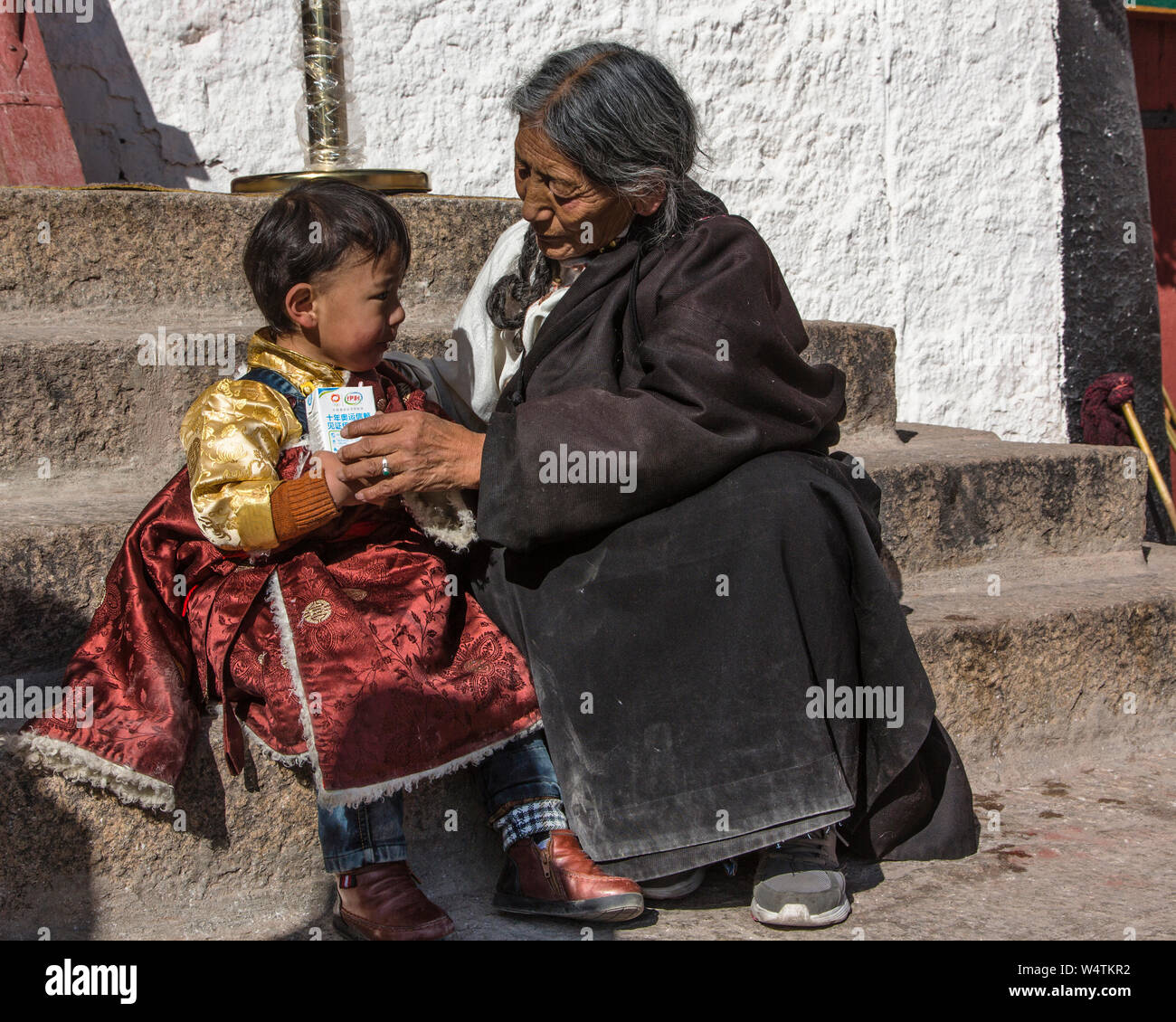 China, Tibet, Lhasa, A Khamba grandmother helps her grandson during a ...