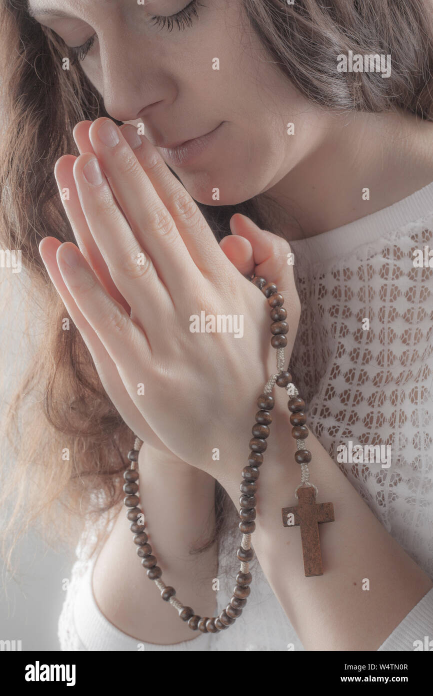 Praying woman on white background with shine Stock Photo - Alamy