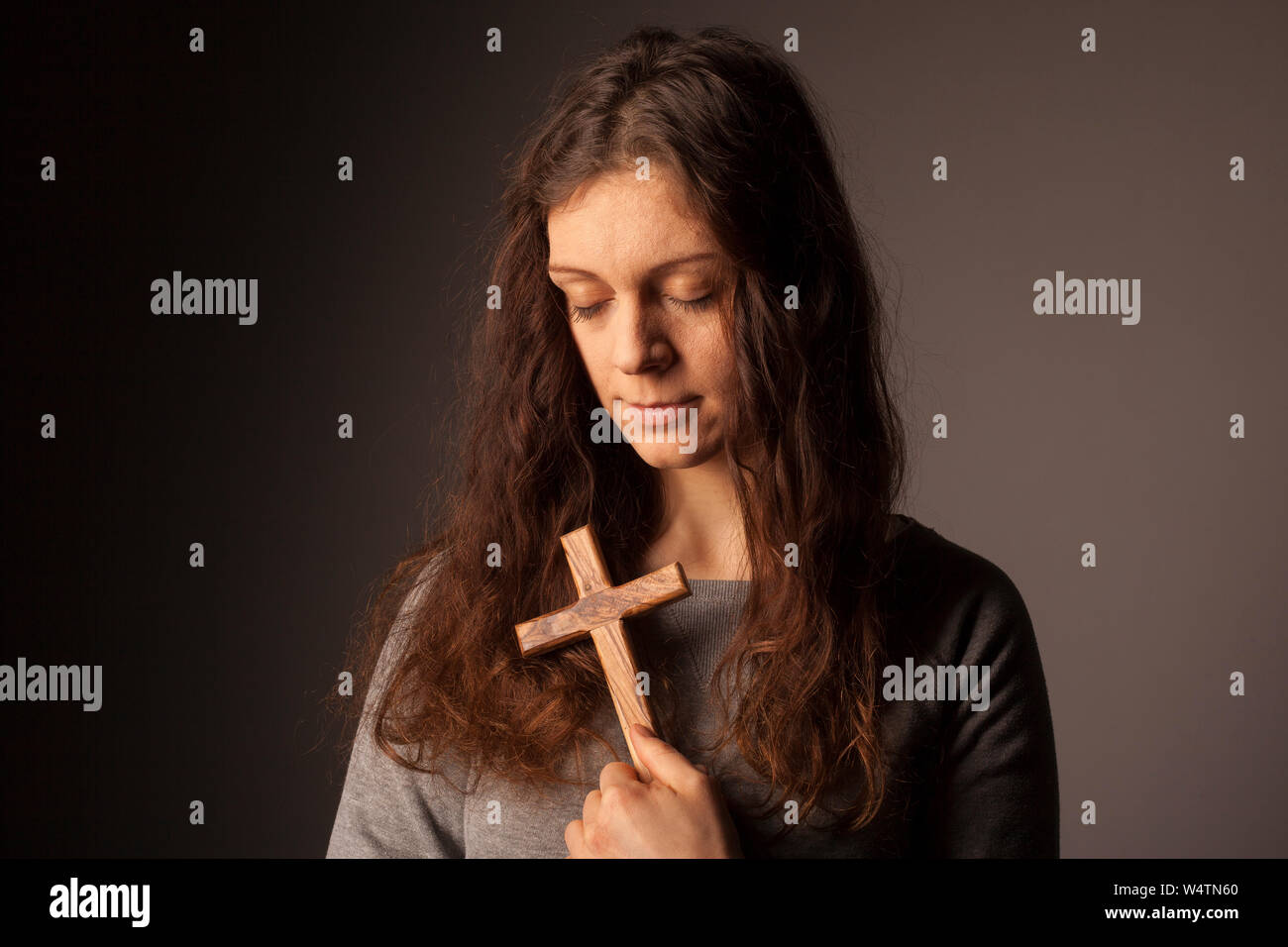 Young christian girl with cross Stock Photo - Alamy