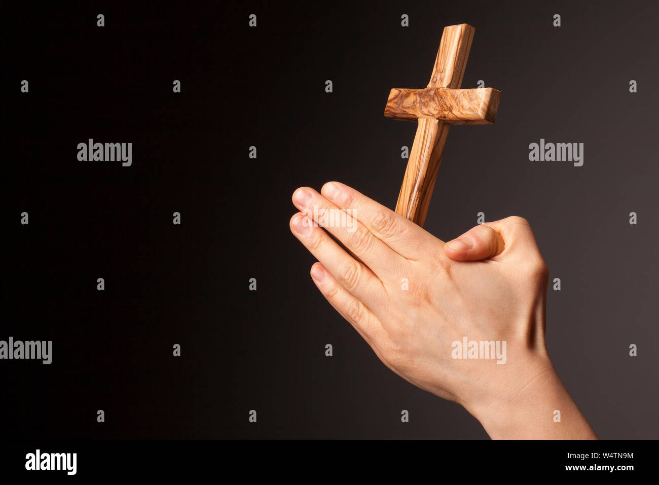 Hands cross on dark hi-res stock photography and images - Alamy