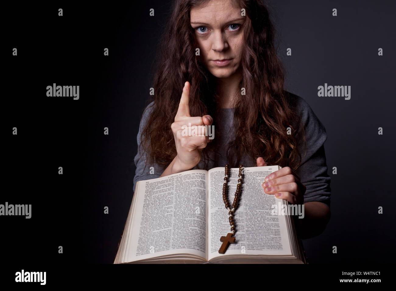 strict Catholic woman forced to read the Bible Stock Photo - Alamy