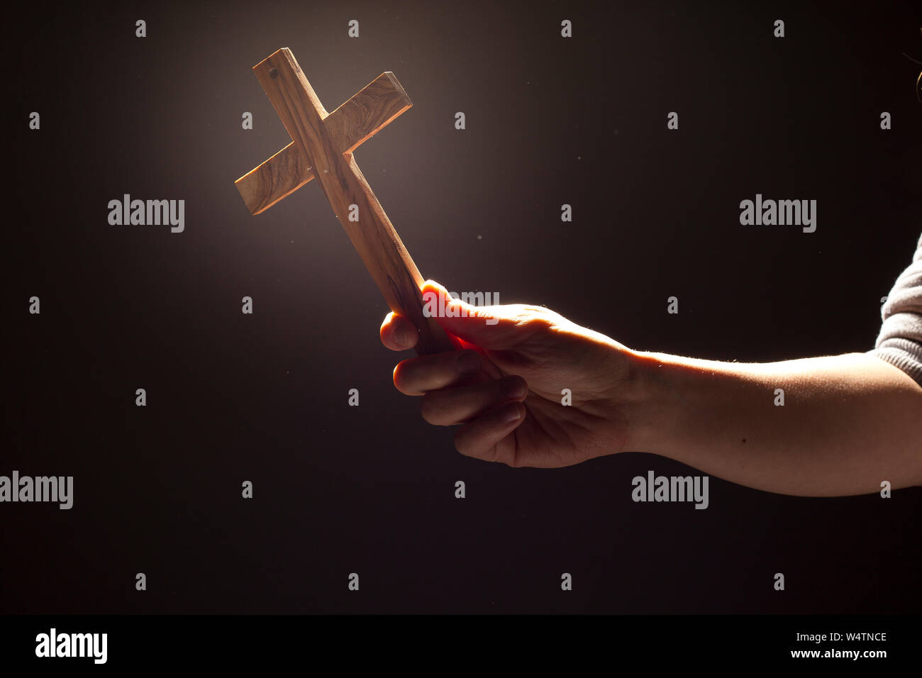 Worship - woman holding cross with qlow Stock Photo - Alamy