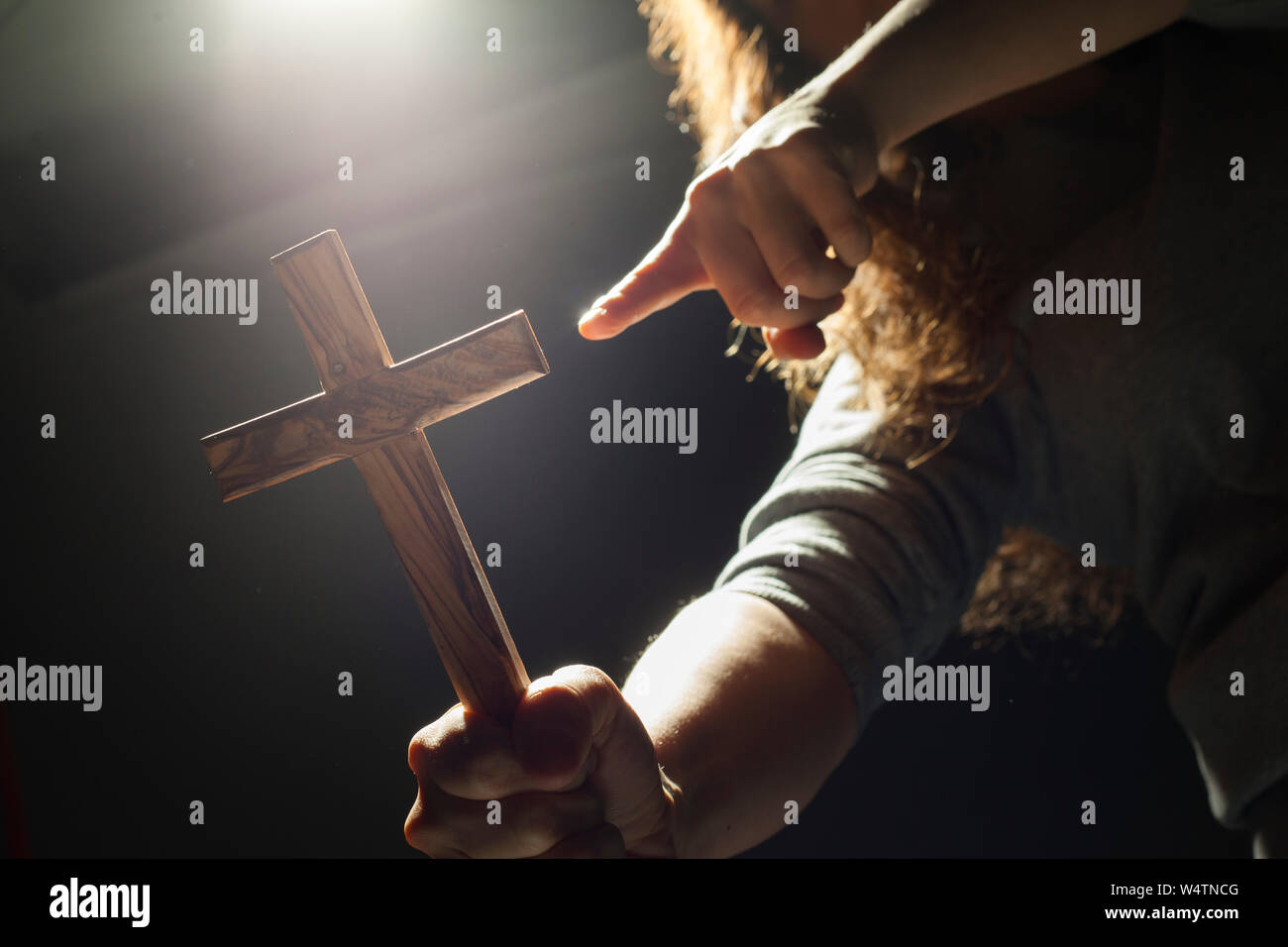 Worship - woman holding cross with qlow Stock Photo - Alamy