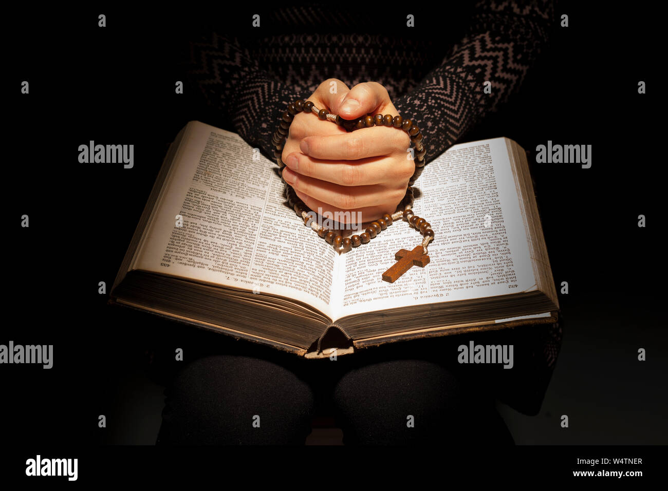 Bible praying hands holding cross hi-res stock photography and images ...