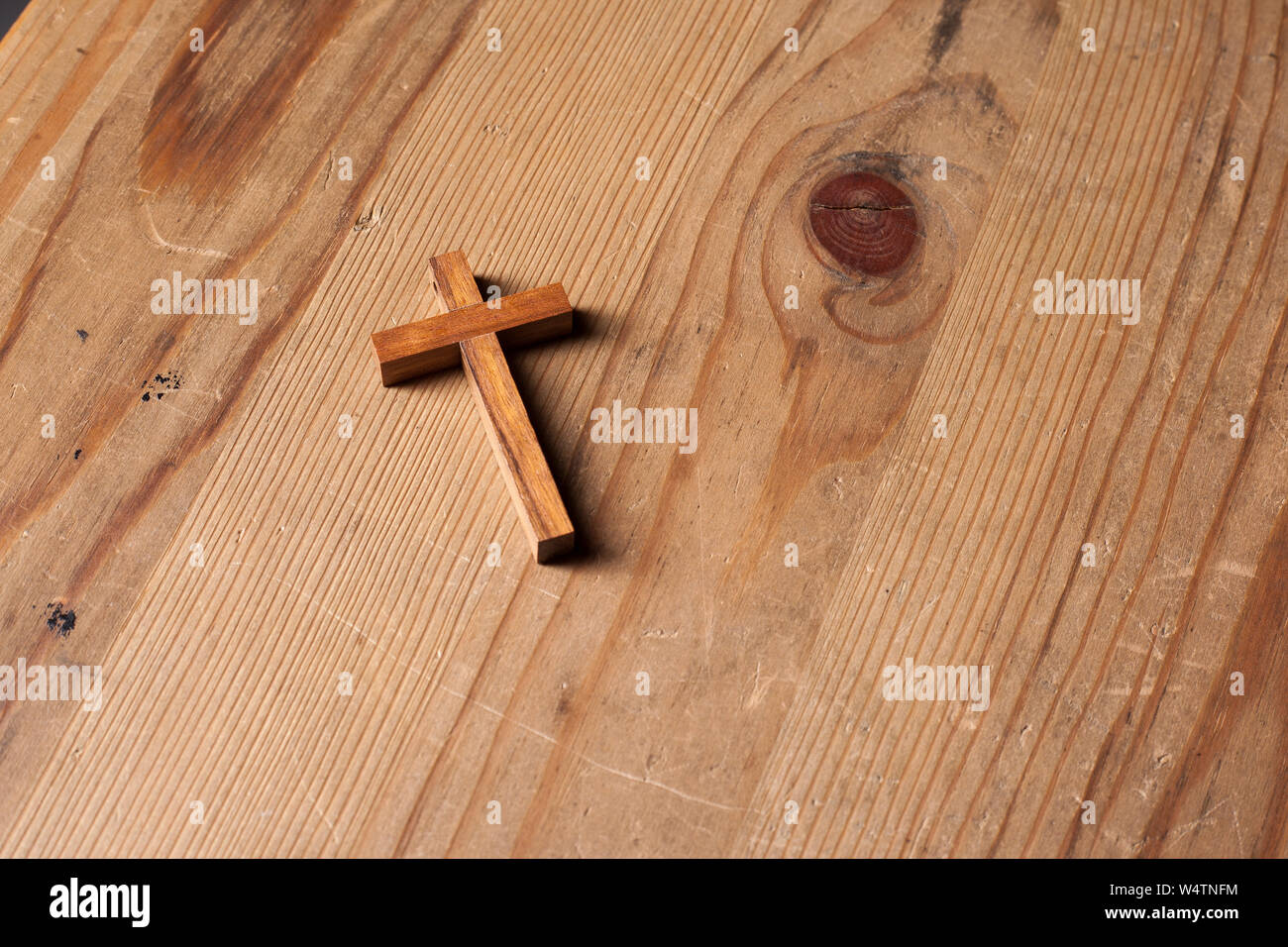 Cross over wood table with window light Stock Photo - Alamy