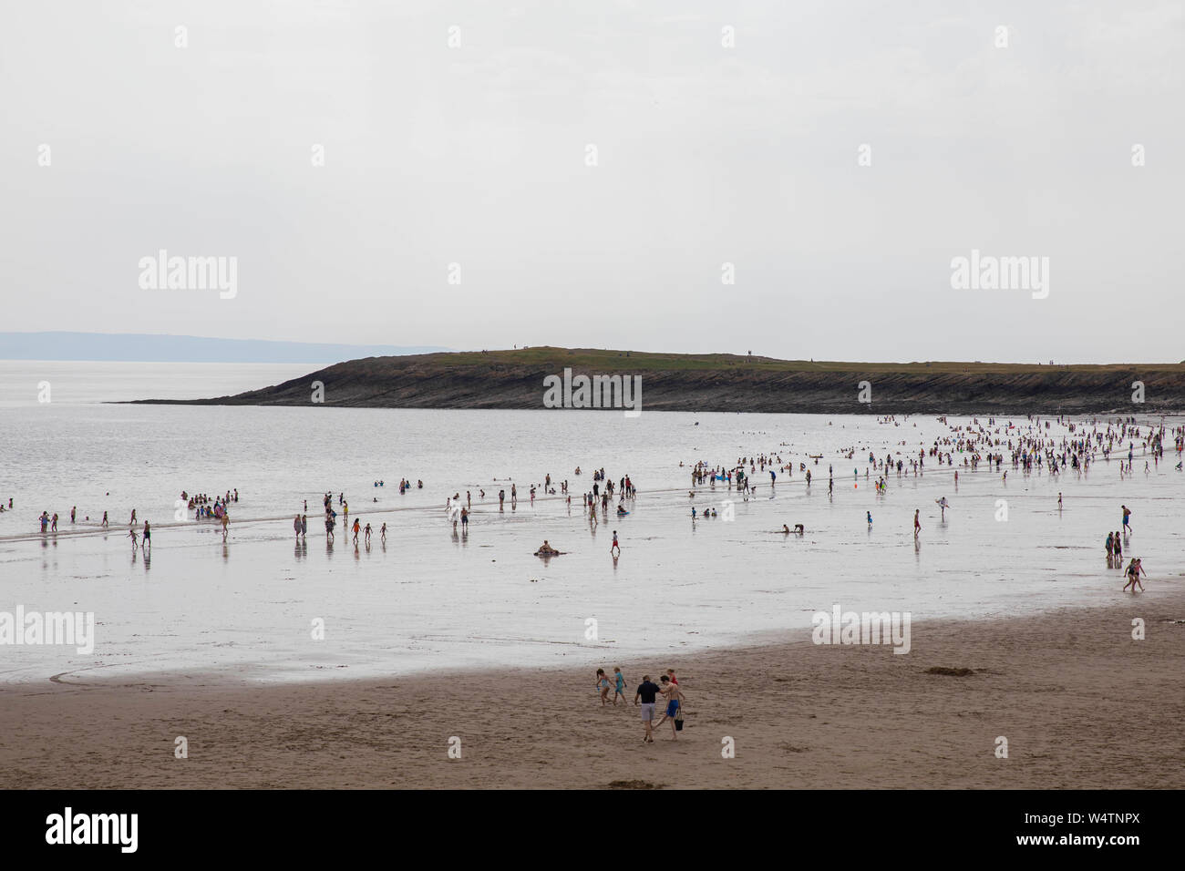 Revellers enjoy a heatwave at the sea's edge on Barry Island beach ...