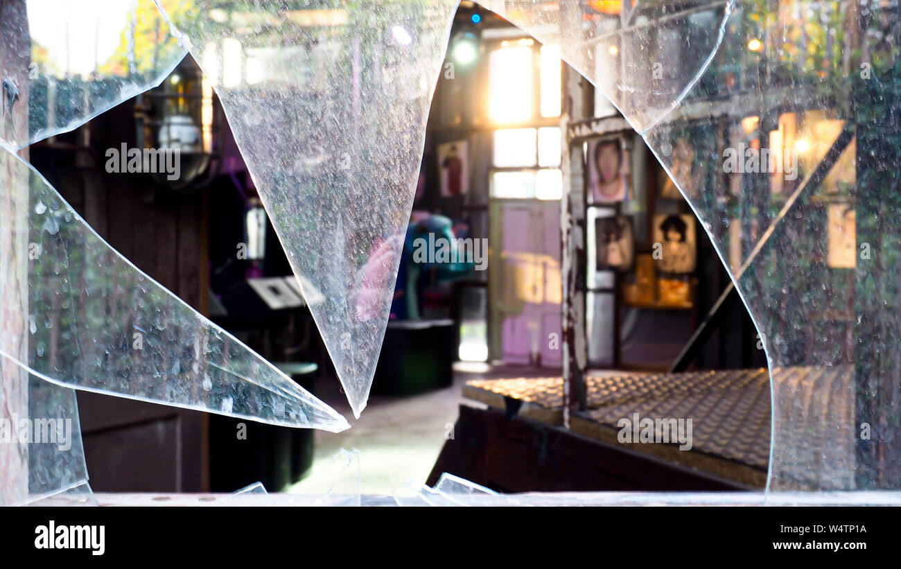 Old dirty Window of an abandoned house with focus on smashed pane ...