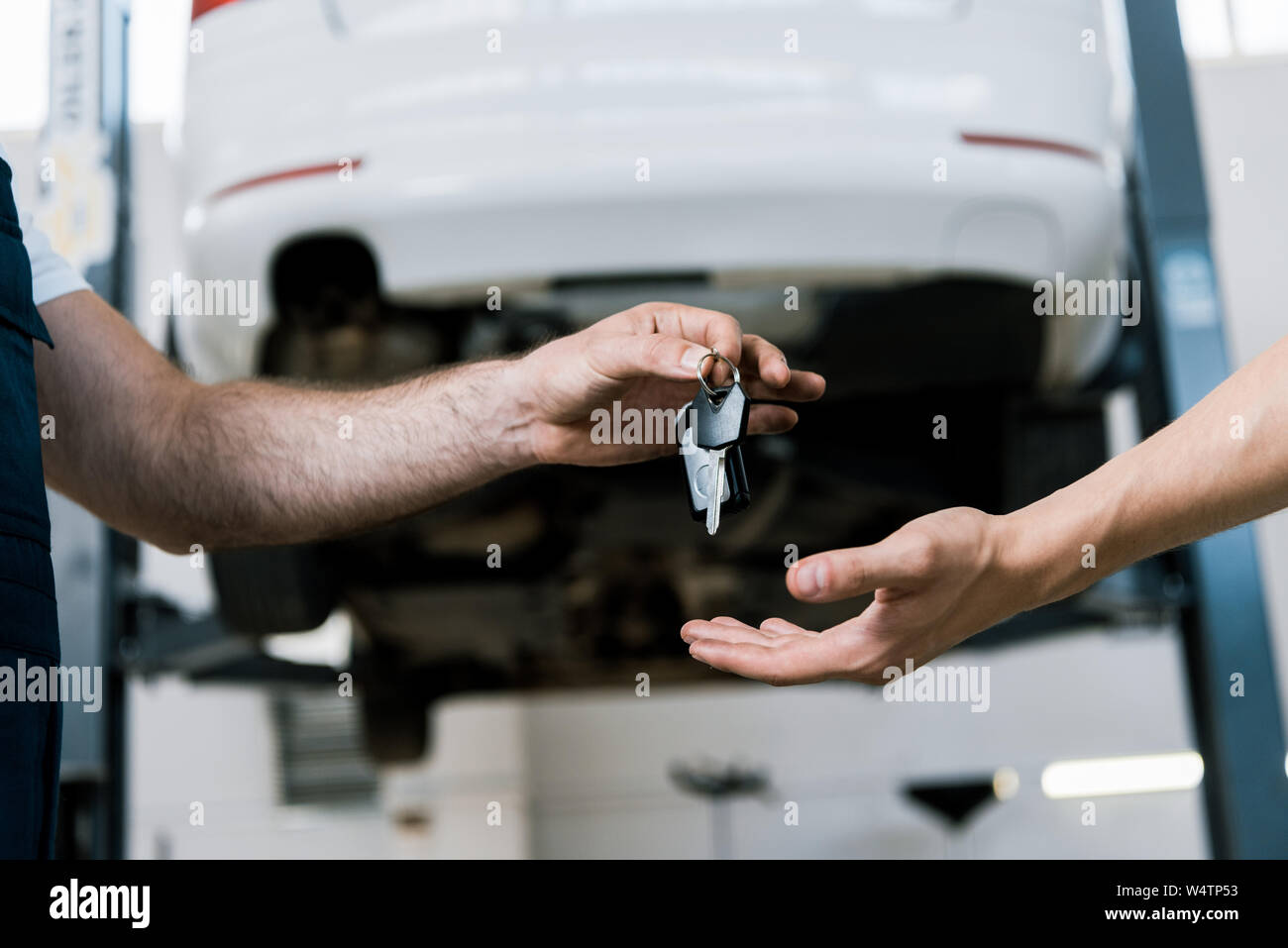 Mechanic giving car key man hi-res stock photography and images - Alamy