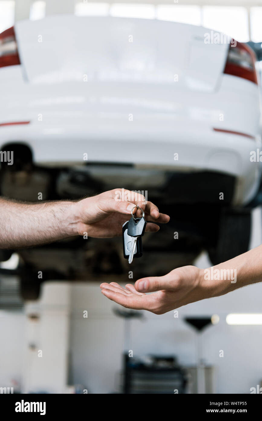 Mechanic giving car key man hi-res stock photography and images - Alamy
