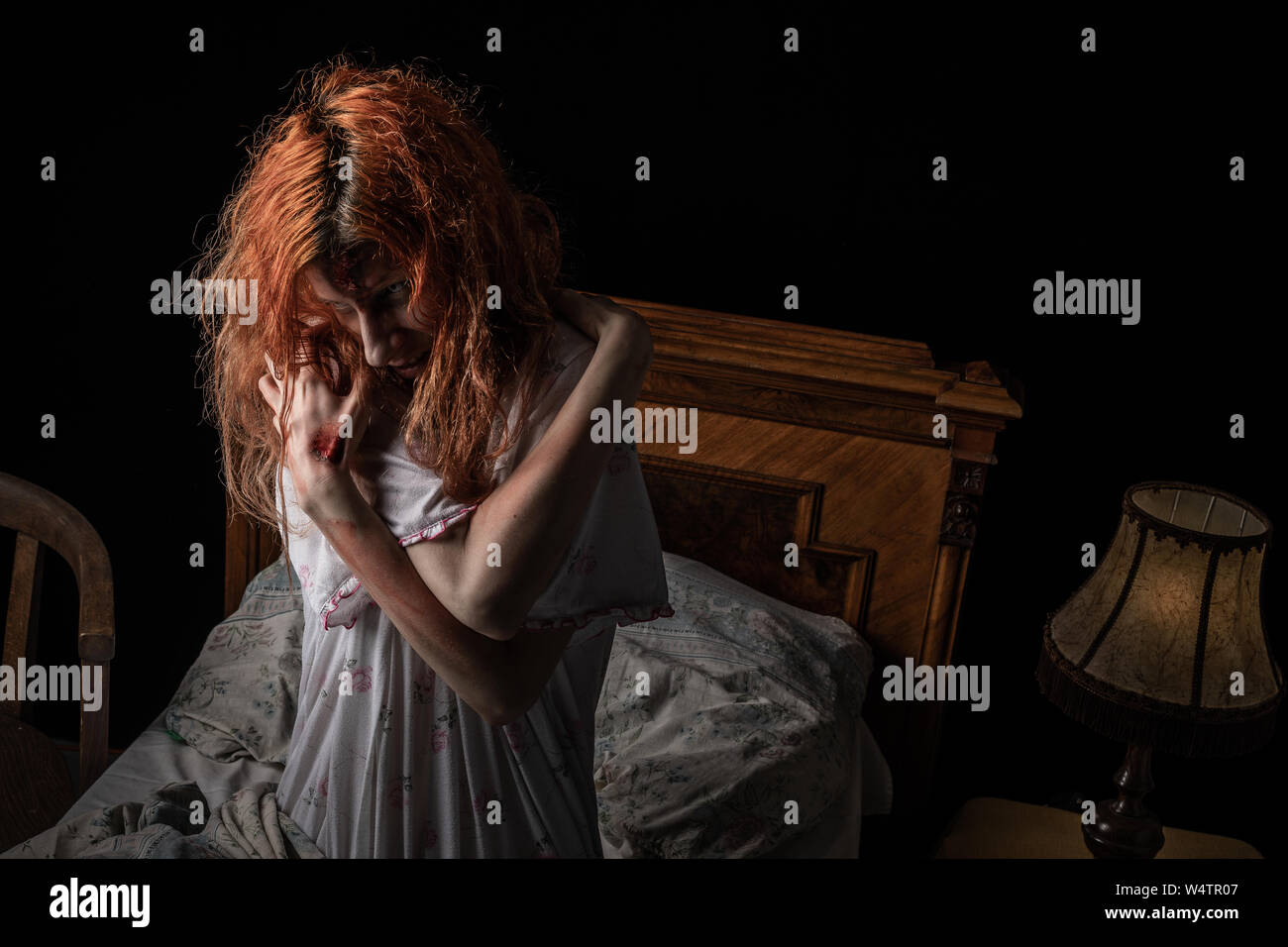 Scary woman possessed by devil in the bed. Exorcism of priest Stock ...