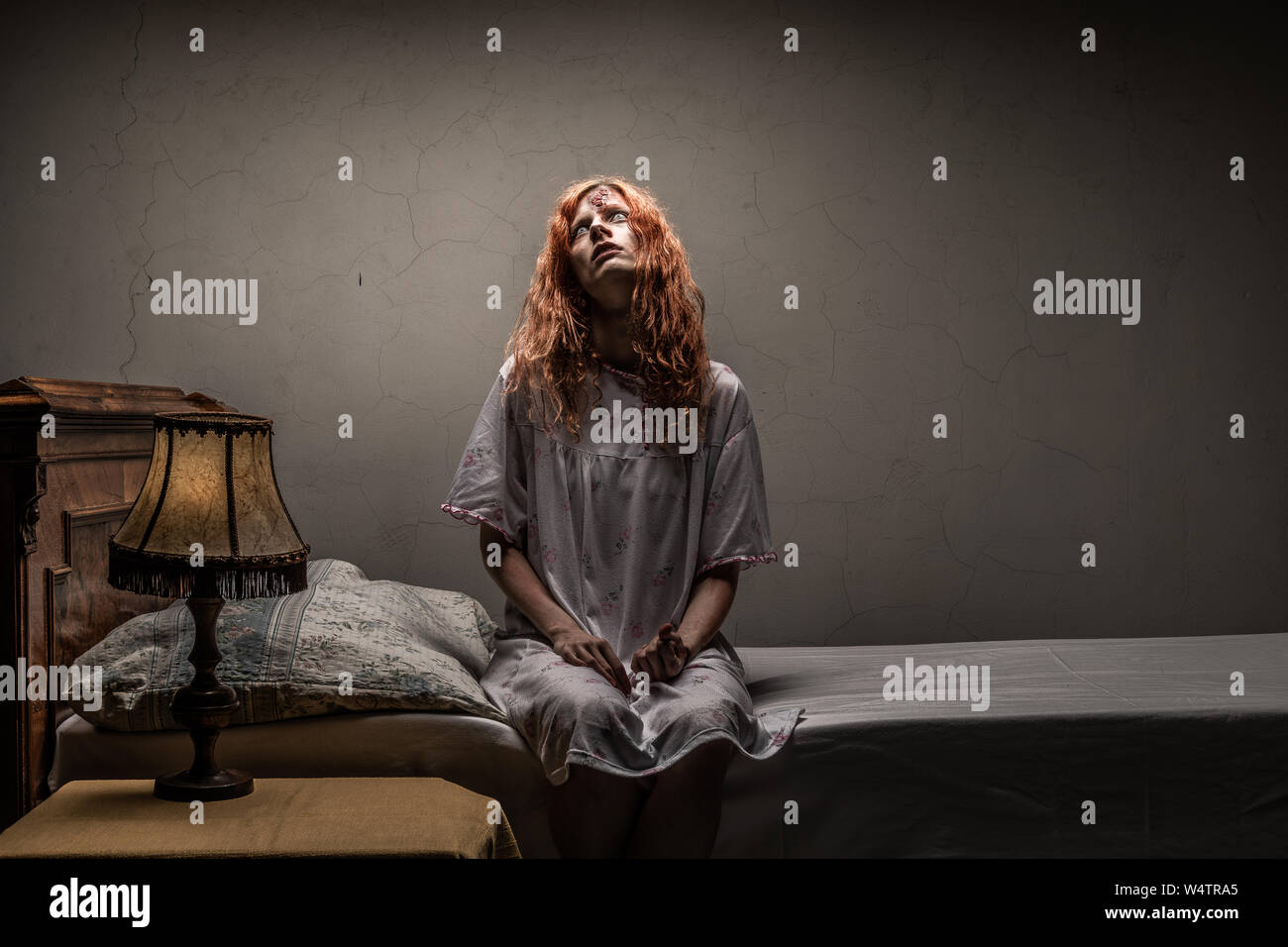 Scary woman possessed by devil in the bed. Exorcism of priest Stock ...