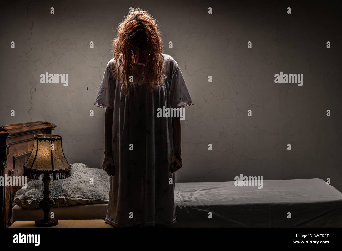 Scary woman possessed by devil in the bed. Exorcism of priest Stock ...