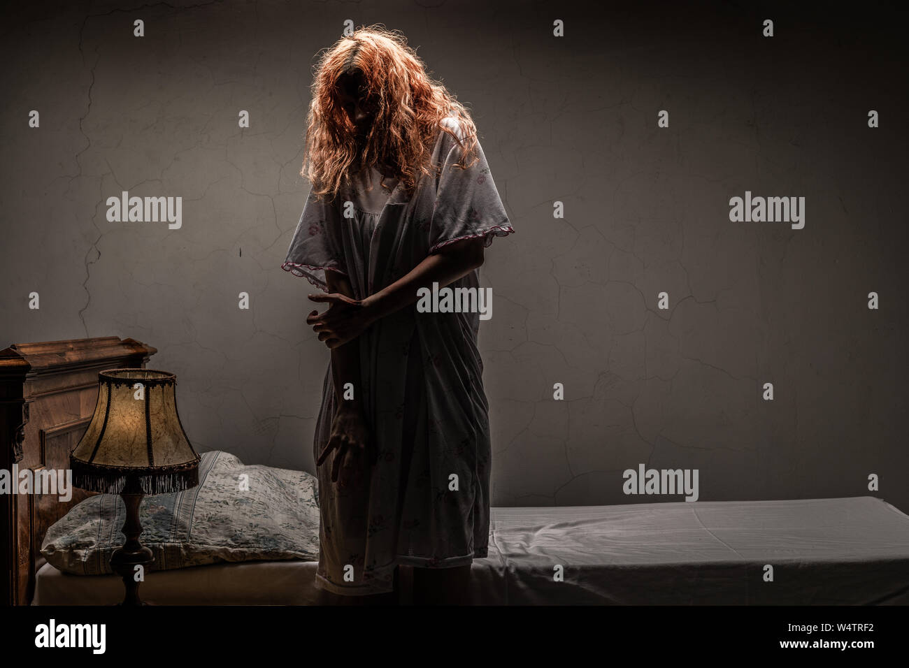 Scary woman possessed by devil in the bed. Exorcism of priest Stock ...