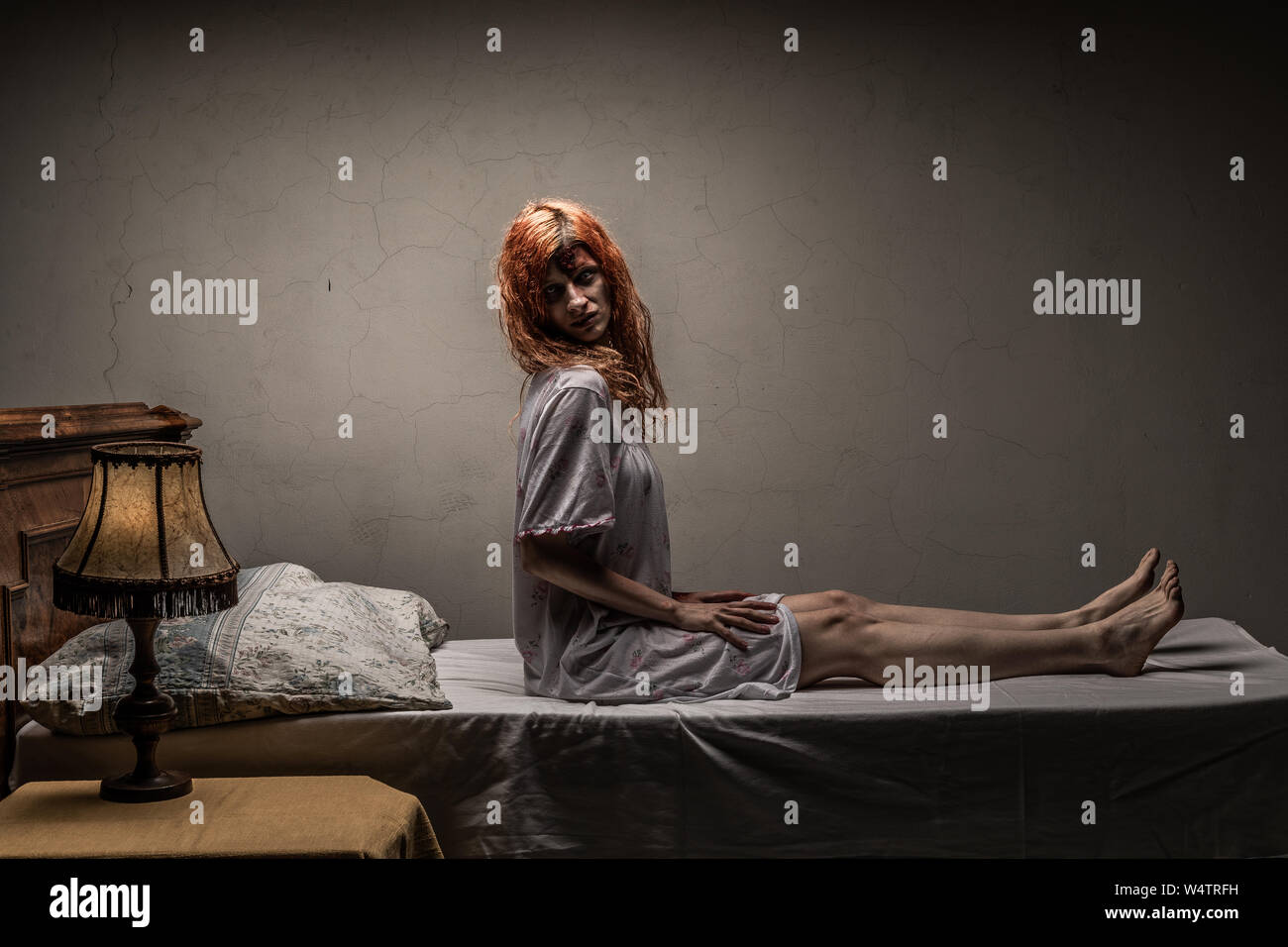 Scary woman possessed by devil in the bed. Exorcism of priest Stock ...