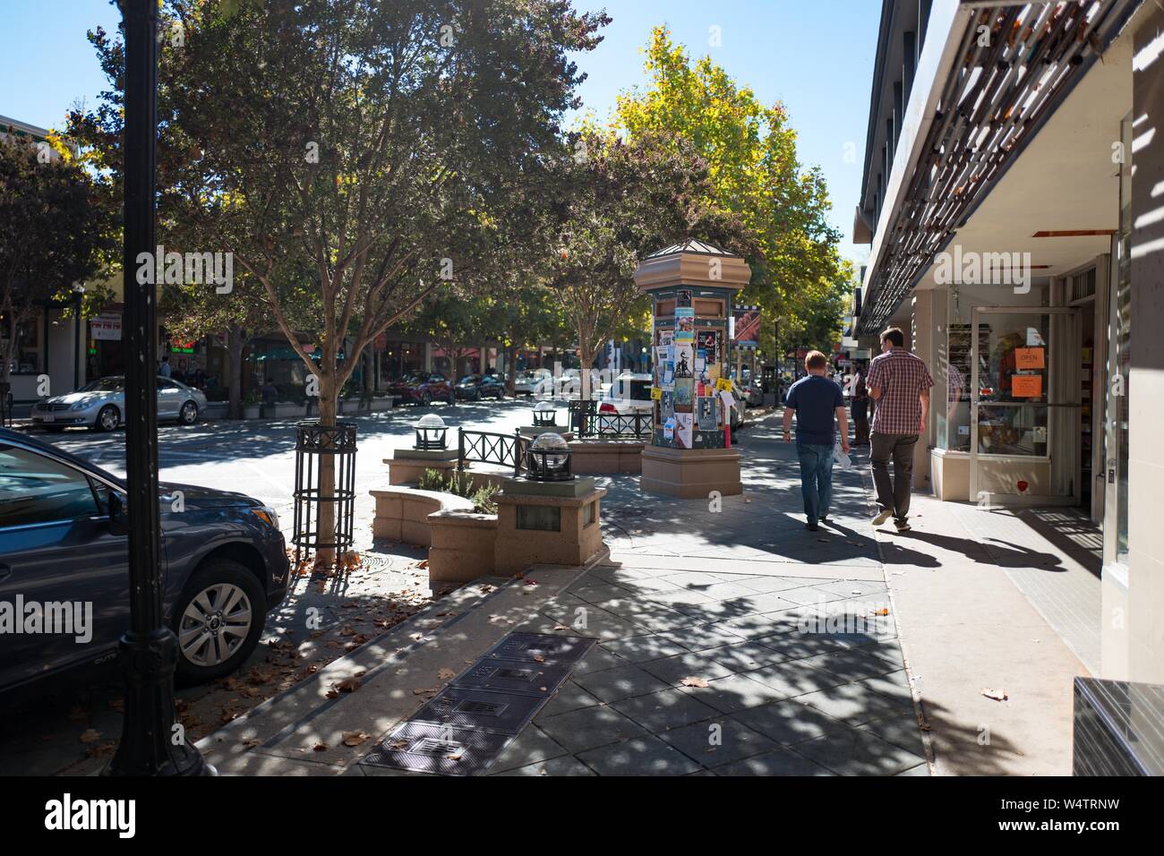 Two people are visible from behind walking down Castro Street in the ...