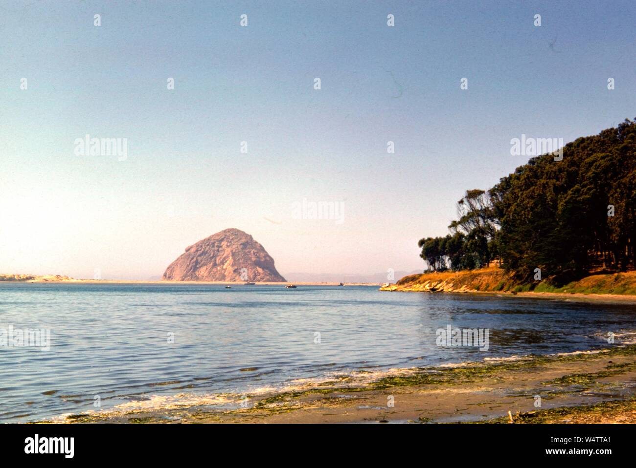 Rock formation and beach with shallow waves breaking, likely located in ...