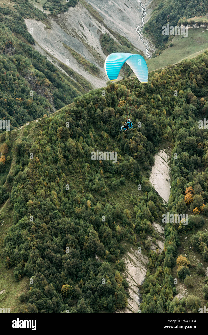 paraglider fly over mountain on a sunny day. Paragliding in the ...