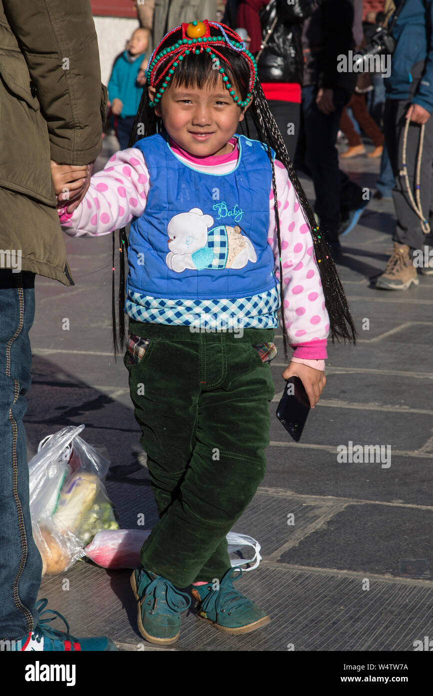 China, Tibet, Lhasa, A young Tibetan girl wears a wig of Khamba style ...