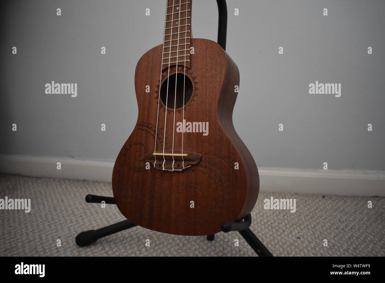 Brown ukulele hi-res stock photography and images - Alamy