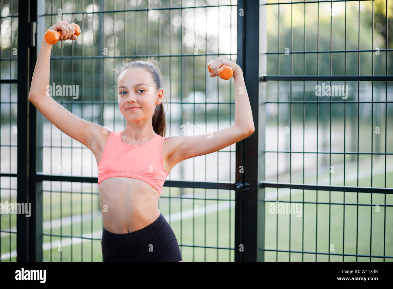 A young, sympathetic girl of slender body, dressed in a form of sport ...