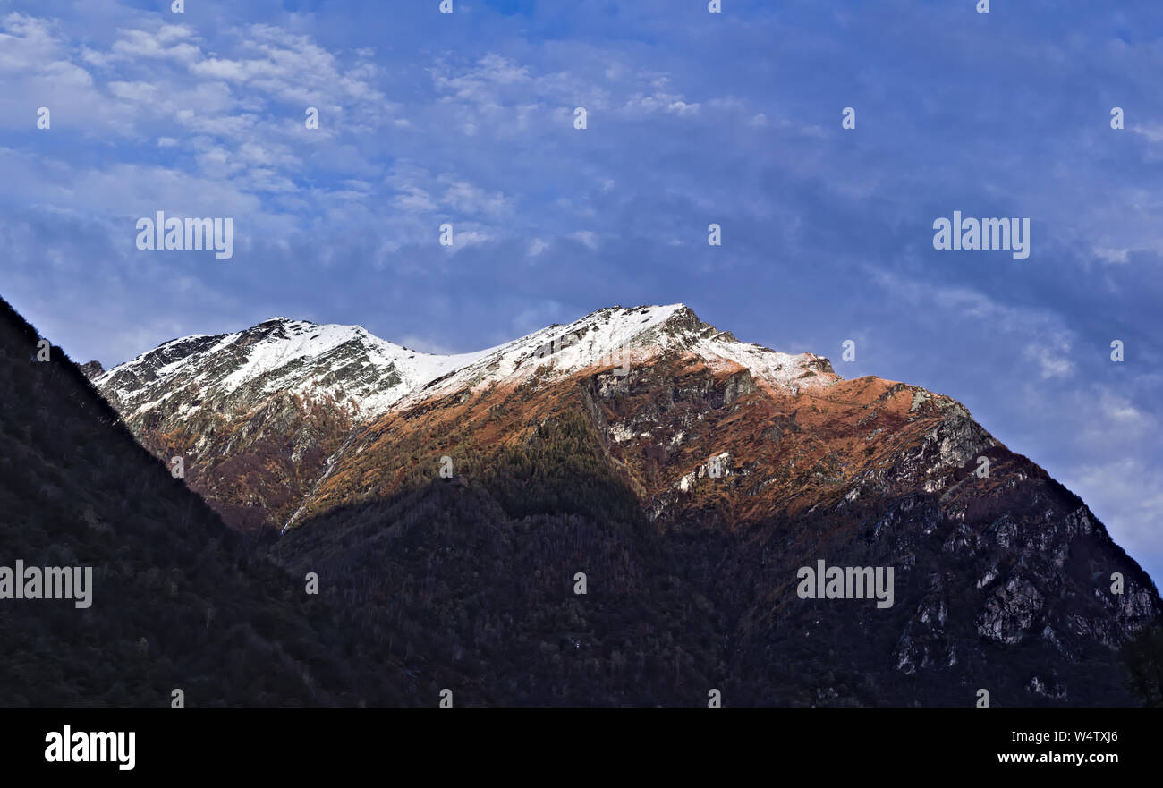 Scenic landscape with snow capped mountain peaks and copy space. Brown ...