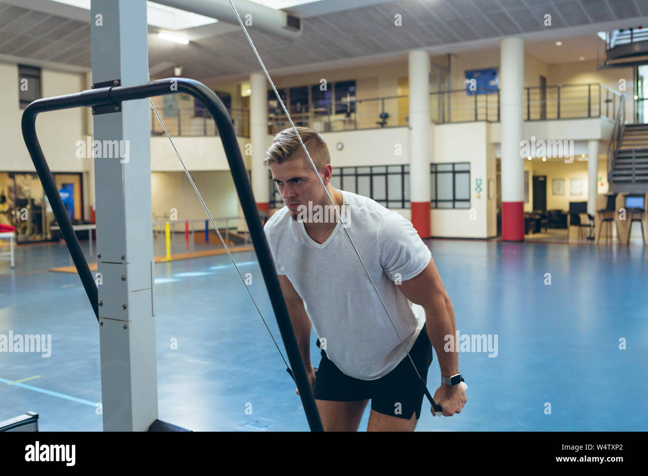 Male athlete doing triceps exercise in fitness studio Stock Photo - Alamy