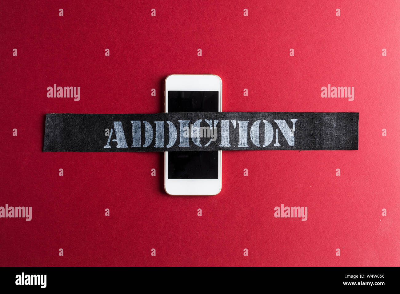 Smart phone addiction concept on red background Stock Photo - Alamy