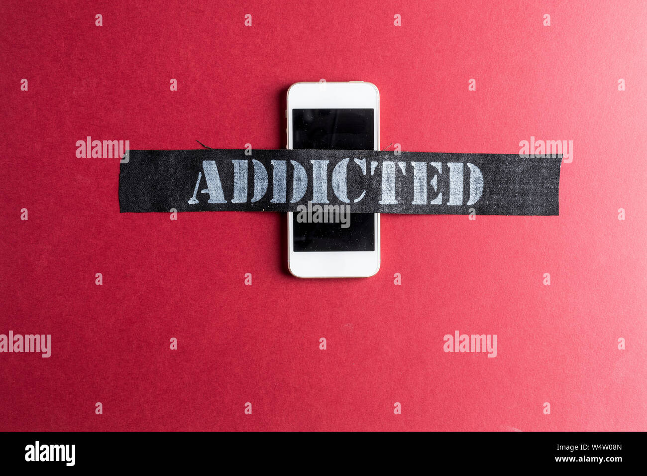 Smart phone addiction concept on red background Stock Photo - Alamy