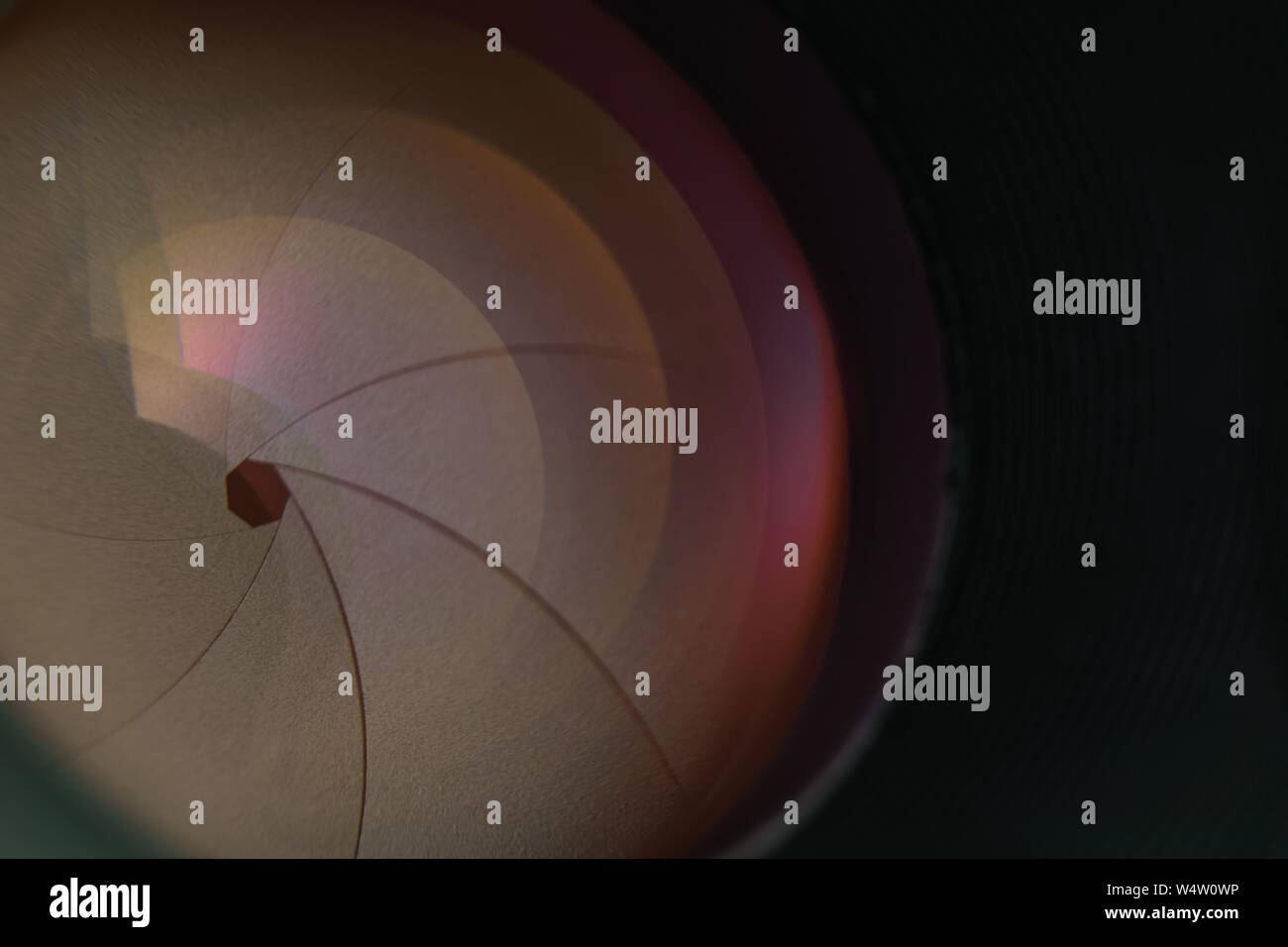 Beautiful camera lens aperture with multi colored reflection on a glass ...