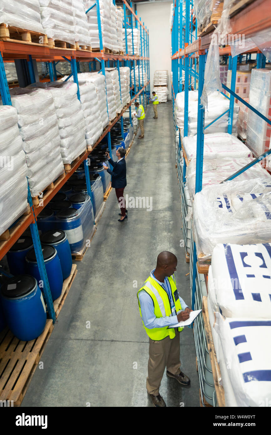 Warehouse staff checking stocks in warehouse Stock Photo - Alamy