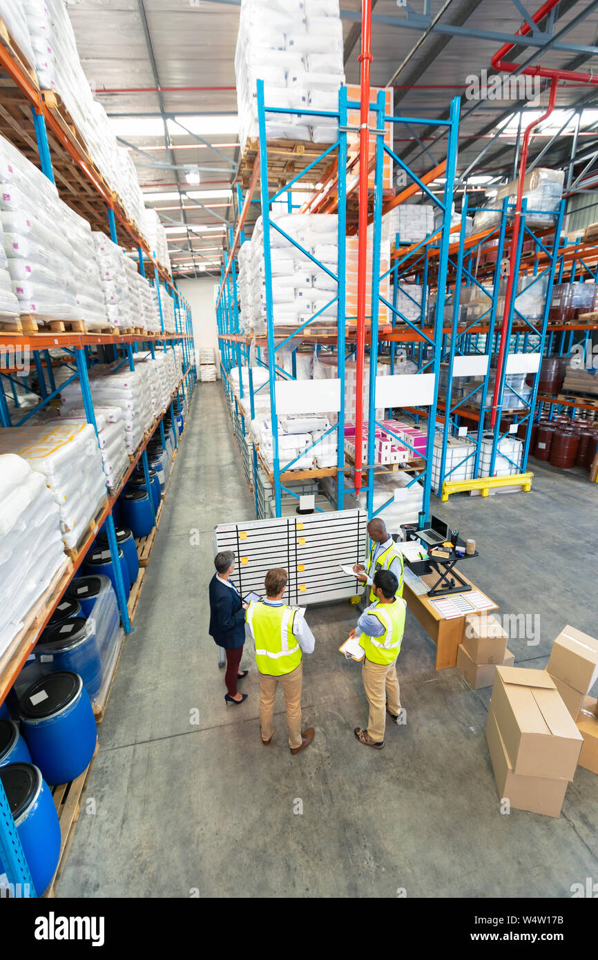 Warehouse staff discussing over whiteboard in warehouse Stock Photo - Alamy