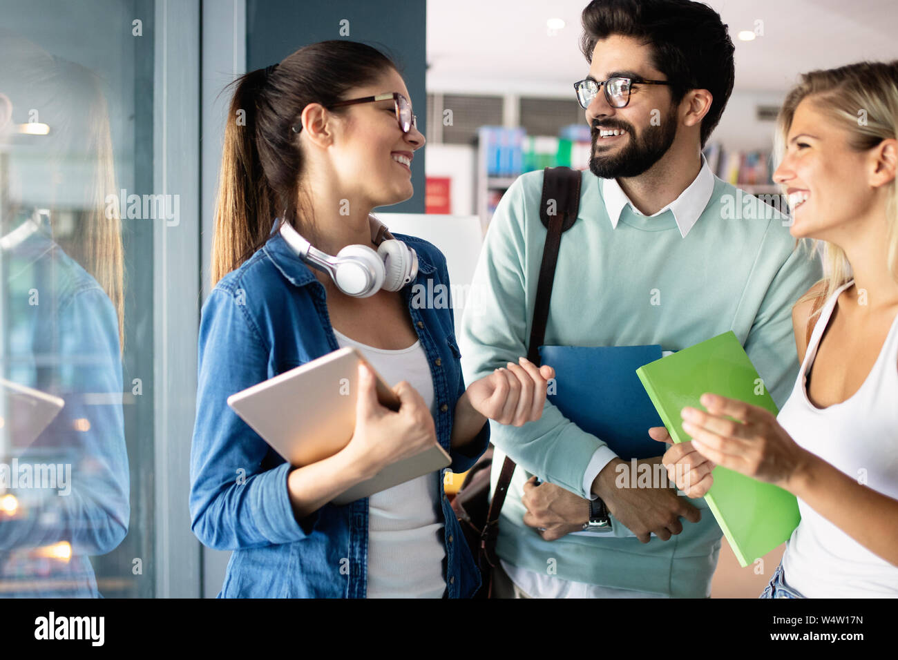 Happy young university students studying together. Group of multiracial ...