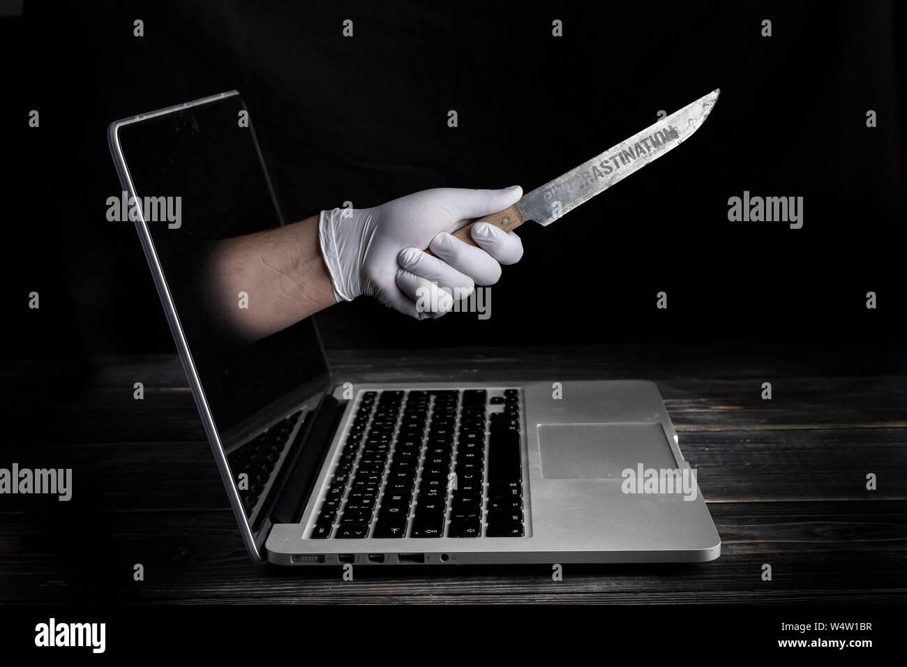 procrastination knife from scren of the laptop procrastination concept ...