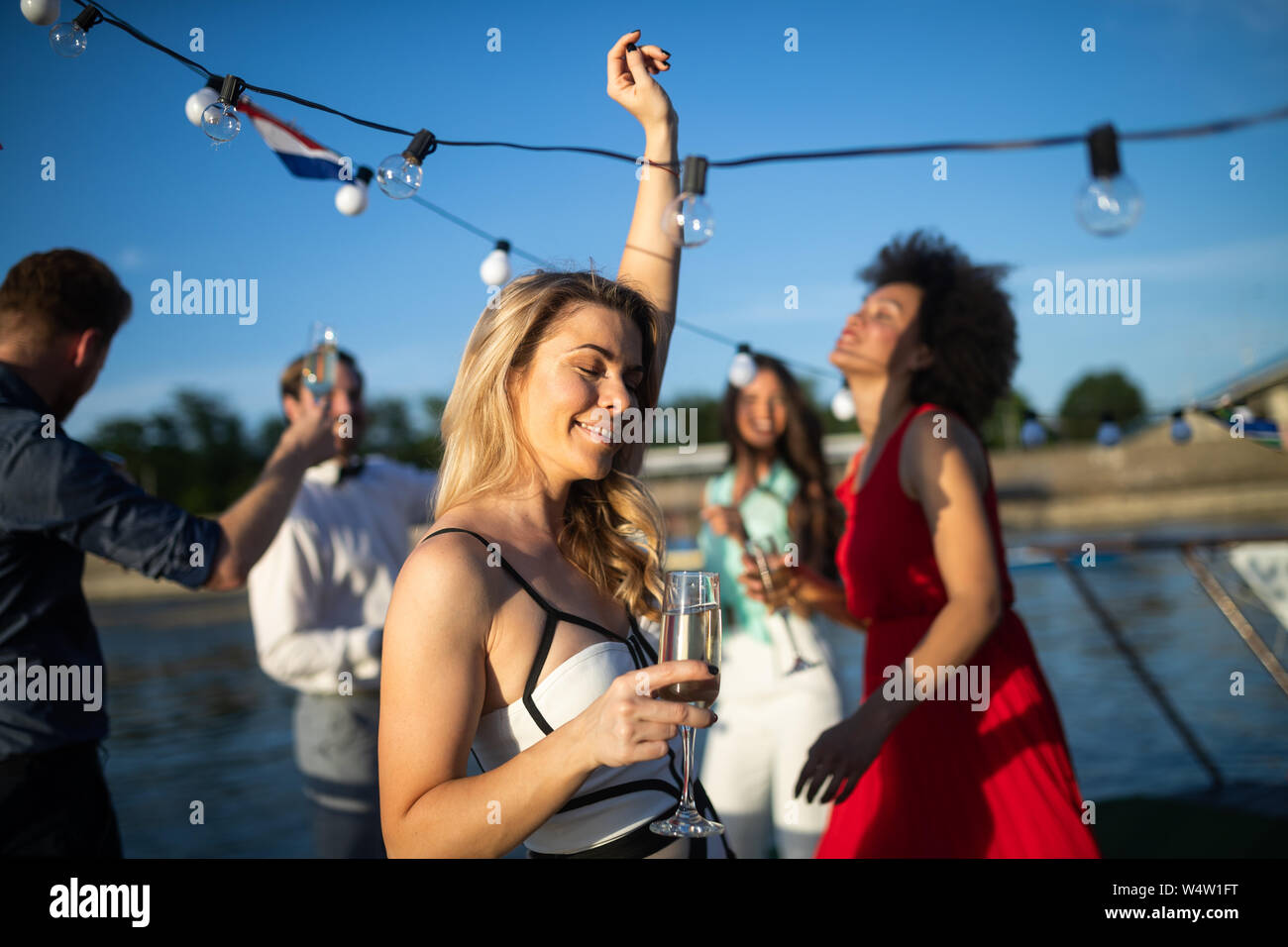 Group of friends at party dancing and smiling together Stock Photo - Alamy