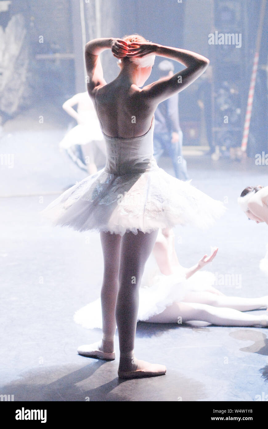 Ballet dancer on stage in repose before a performance of Swan Lake ...
