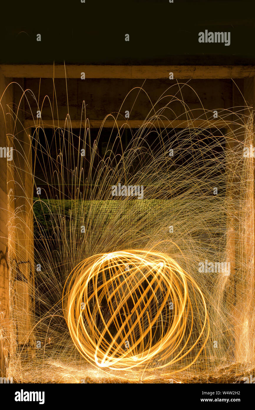 Light painting / light drawing with fire and steel wool in the city ...
