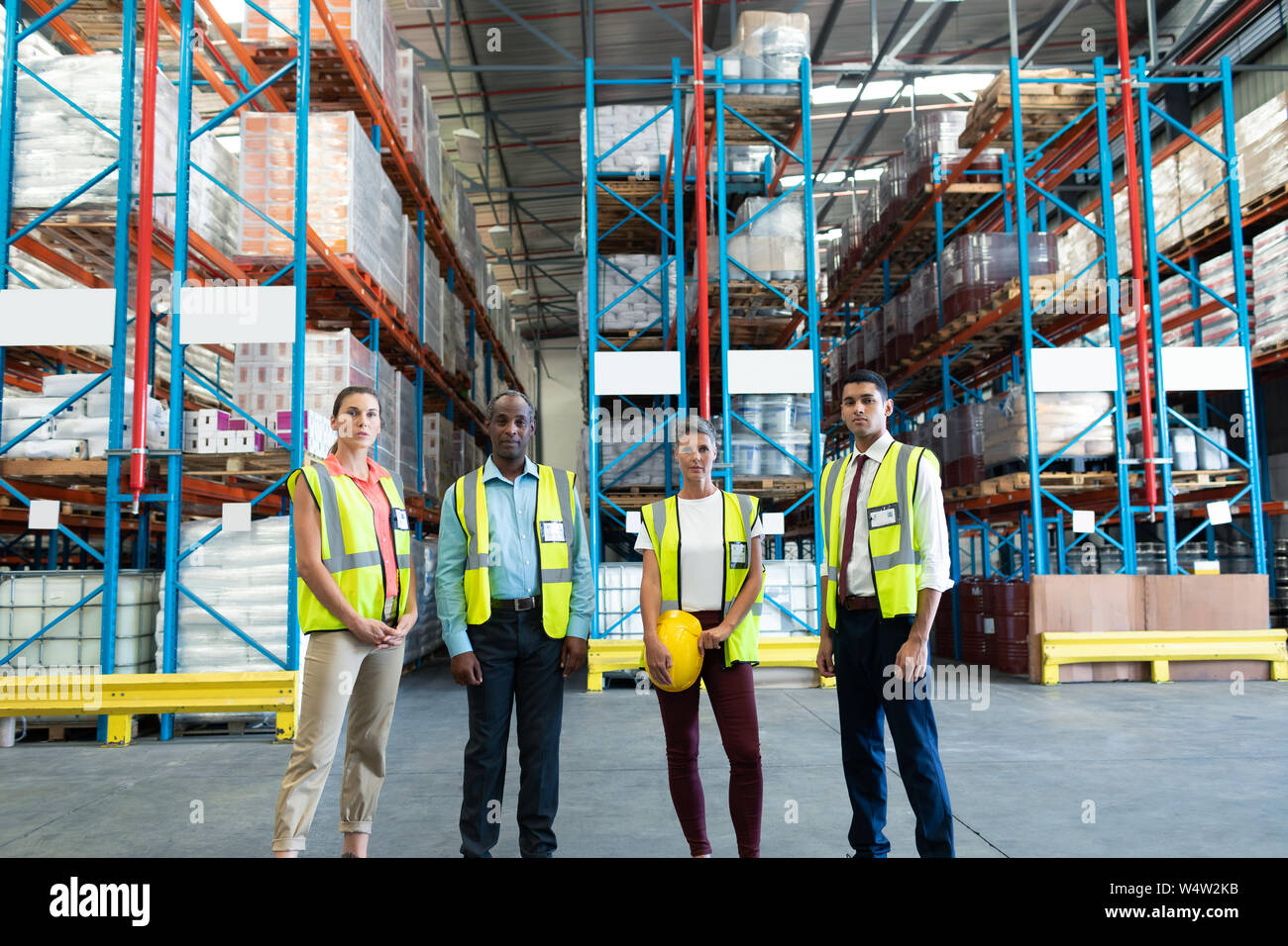 Warehouse staffs standing together in warehouse Stock Photo - Alamy