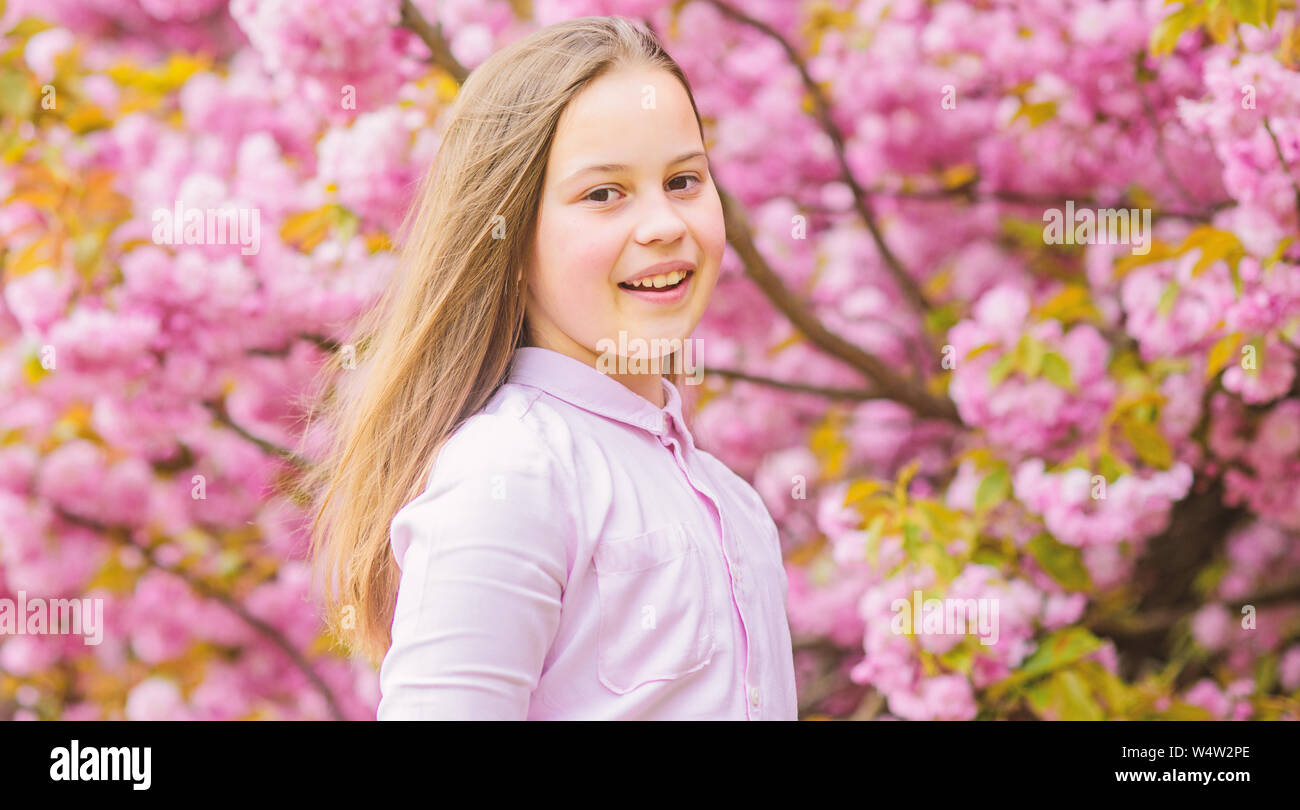 Little girl enjoy spring. Kid on pink flowers of sakura tree background ...