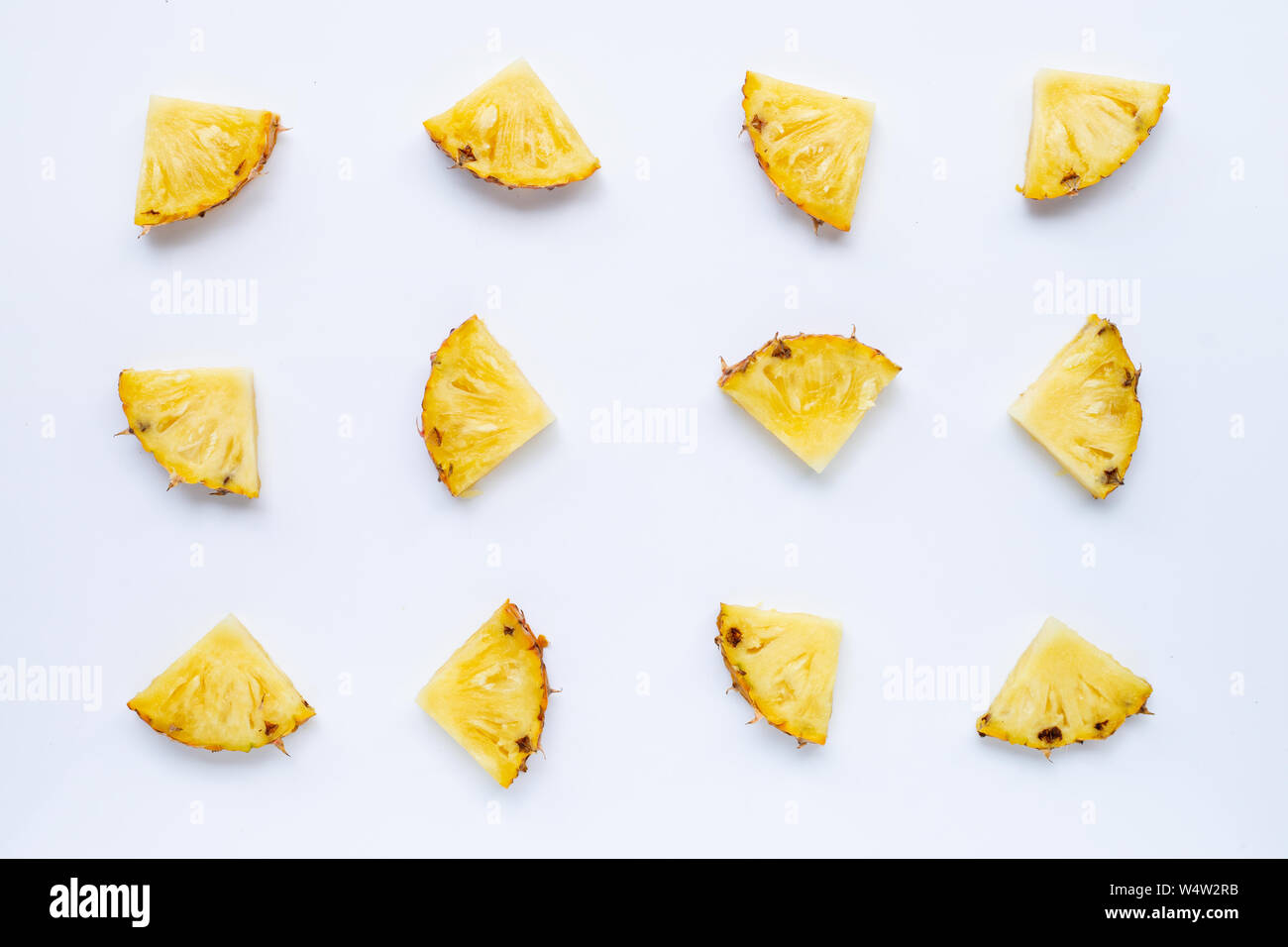 Pineapple slices on white background Stock Photo - Alamy