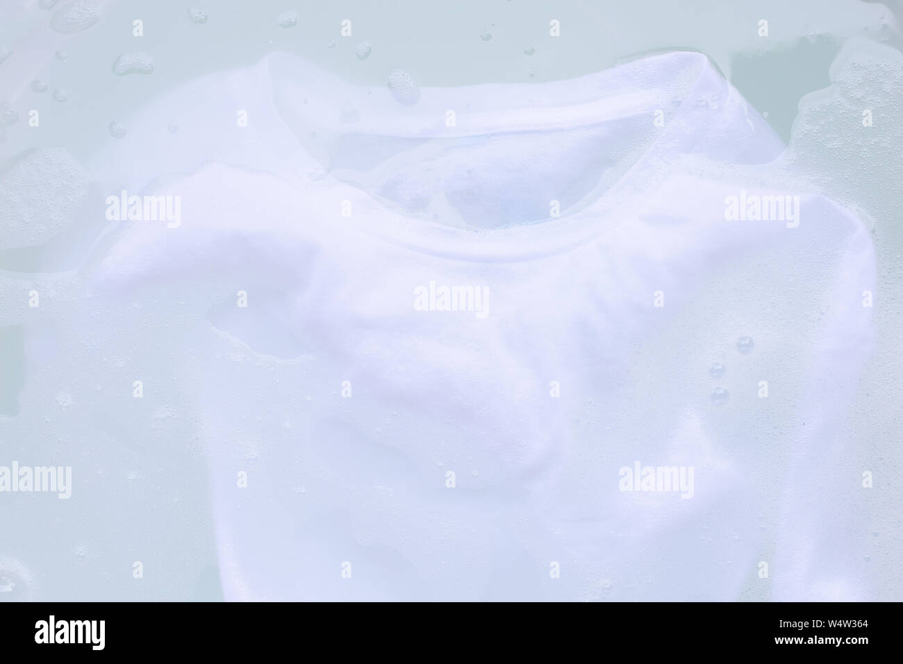 Soak a cloth before washing, white T-shirt Stock Photo - Alamy