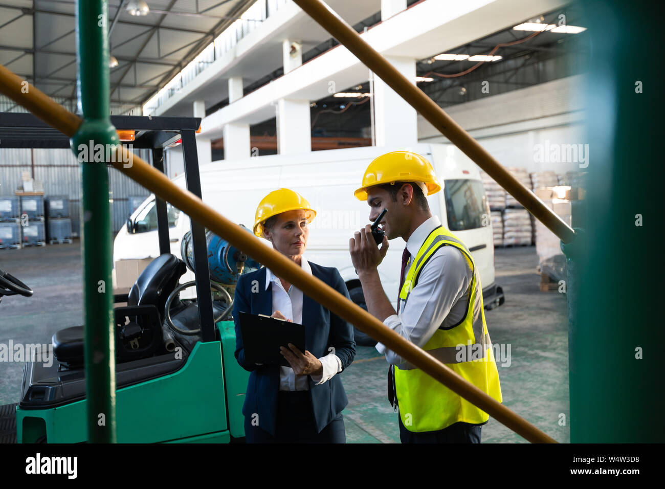 Female manager and male supervisor working together in warehouse Stock ...