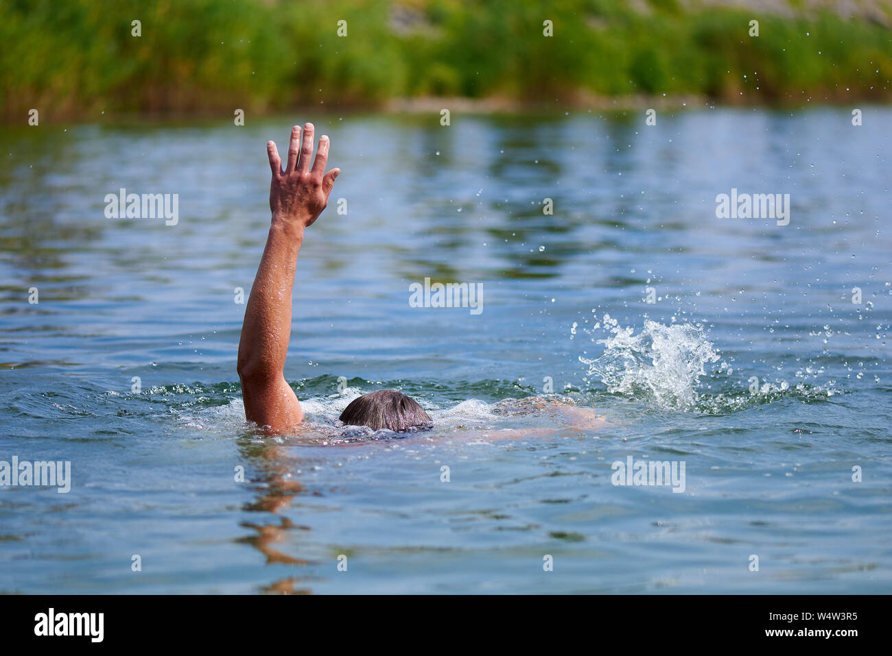 A drowning man in a pond. Accidents on the water Stock Photo - Alamy