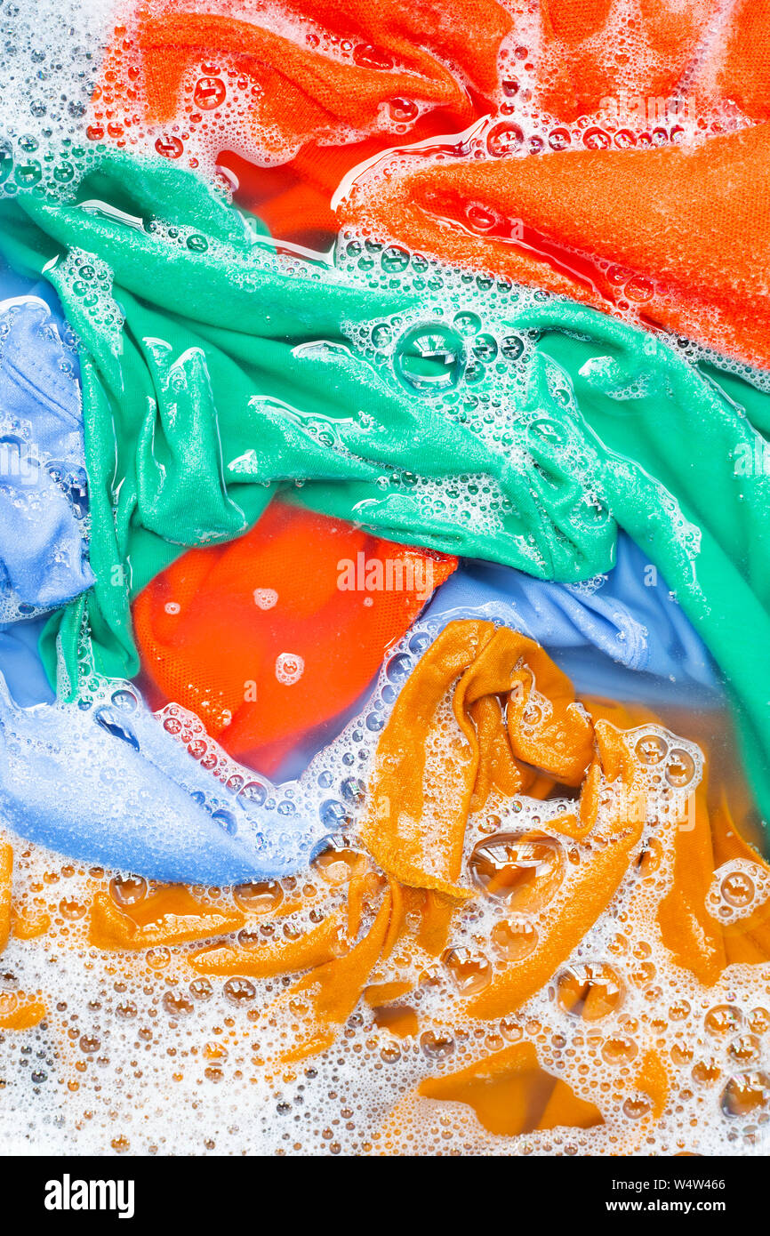 Color clothes soak before washing. Top view Stock Photo - Alamy