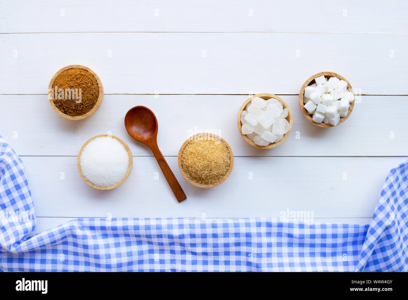 Various types of sugar on wooden background Stock Photo - Alamy