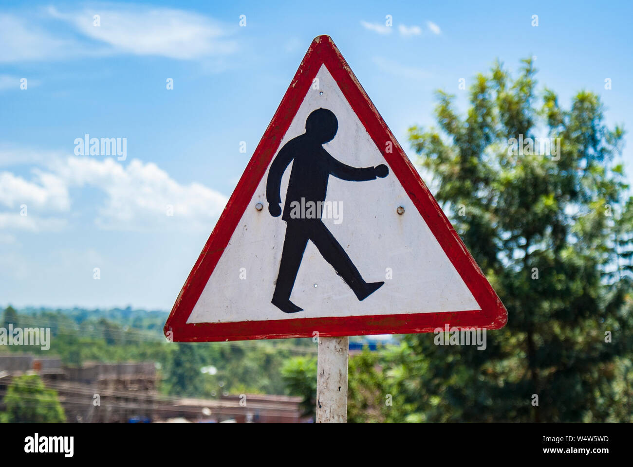 Bespoke painted road sign in Metu town, Ethiopia, showing man walking ...